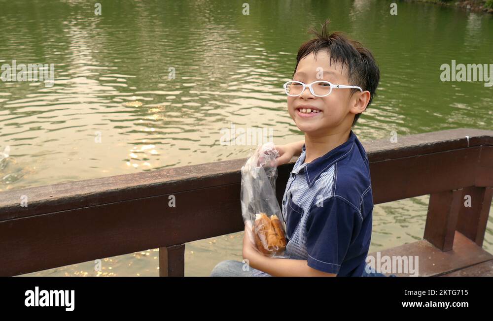 Boy feeding fish Stock Videos & Footage - HD and 4K Video Clips - Alamy