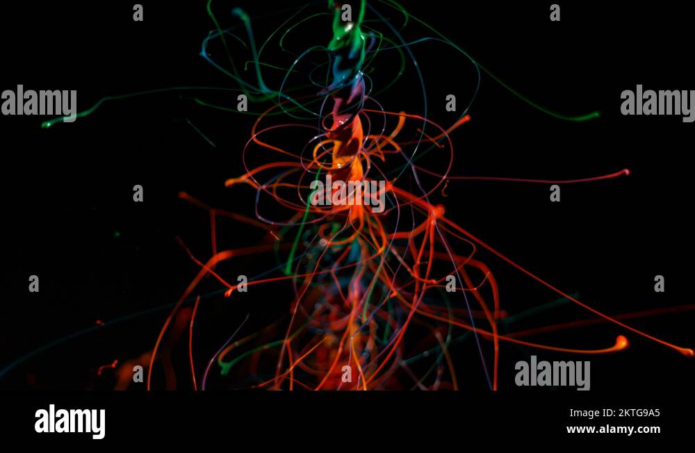 A rainbow swirl of colors spiraling away shot vertically in slow motion ...
