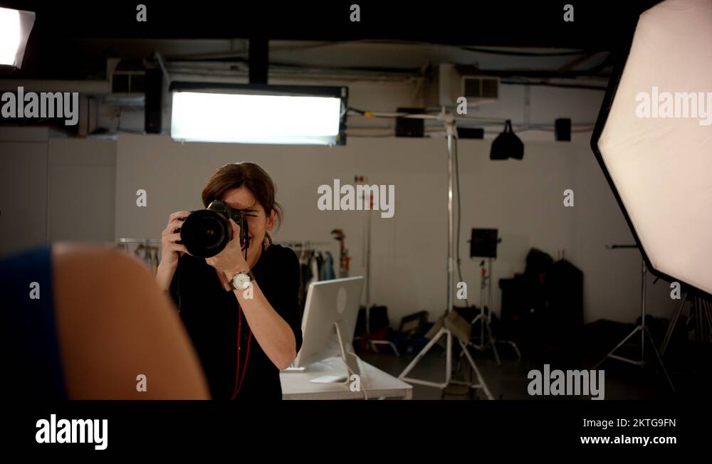 Female photographer photographing fashion model at studio Stock Video ...