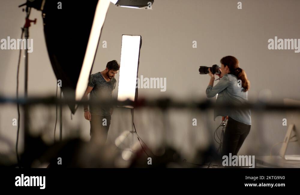 Female photographer photographing fashion model at studio Stock Video ...