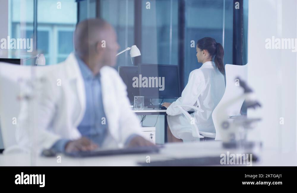 4K Scientist in white coat using interactive touch screen in modern lab ...