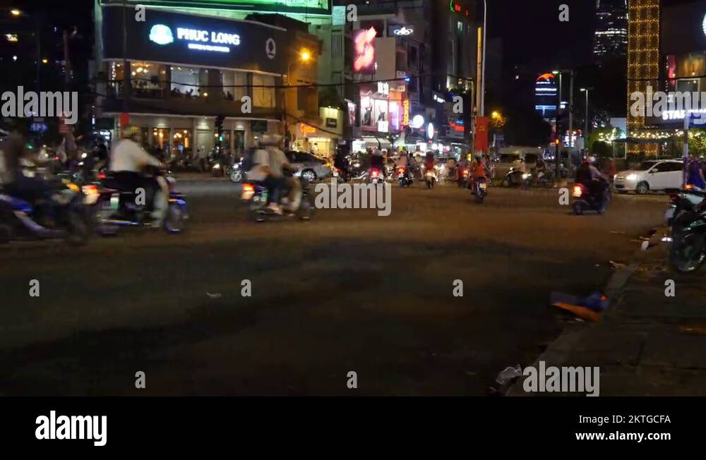 busy city centre traffic intersection night lights crowd cars people ...