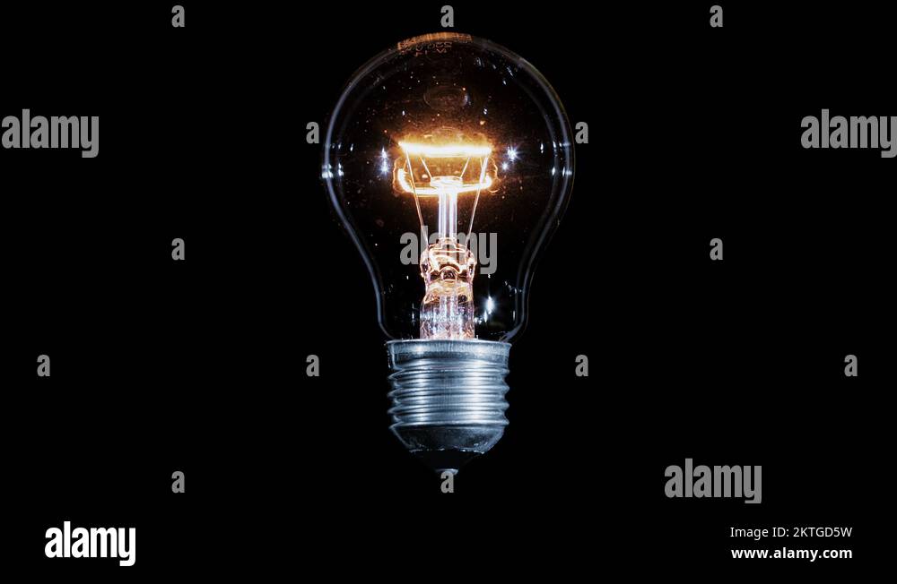 Tungsten light bulb lamp blinking over black background, loop Stock ...