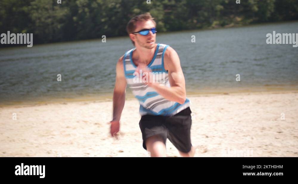 Running and Catching Frisbee Flying Disc on Beach at Lake, 4K Stock ...