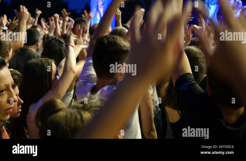 Crowd people teenager spectators fan clapping cheering by concert stage ...
