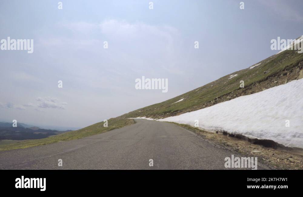 Car driving on paved road above timber line on Mount Evans-POV point of ...