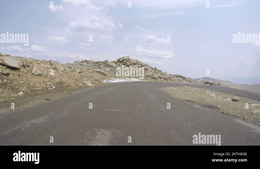 Car driving on paved road above timber line on Mount Evans-POV point of ...