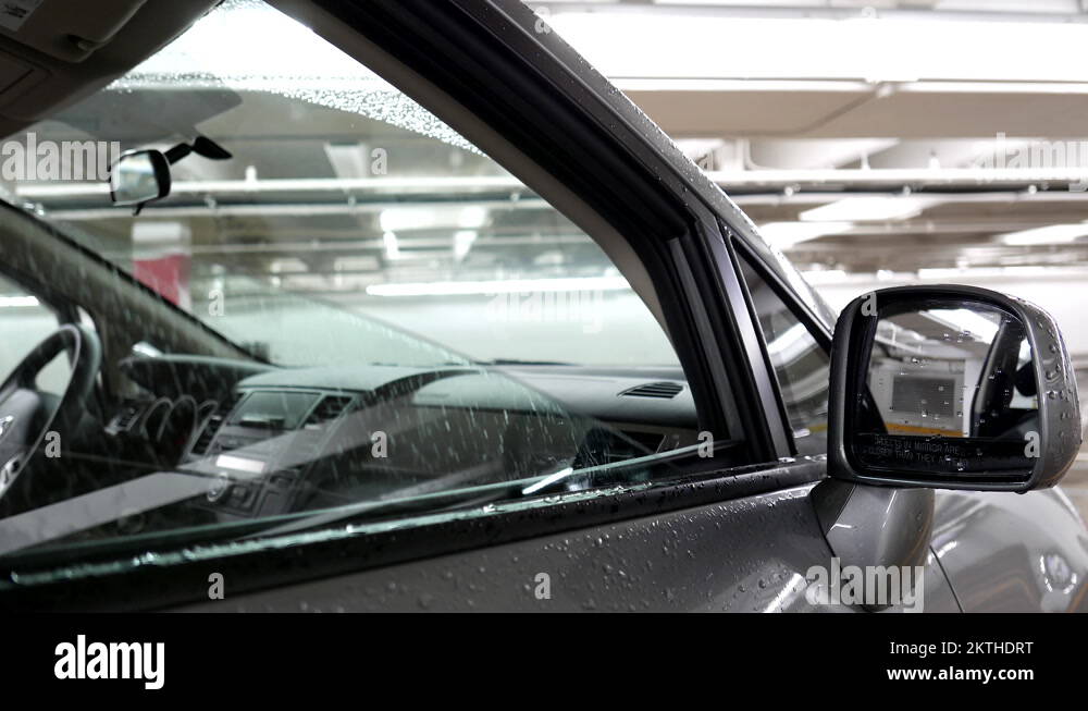 Close up opens window of car inside parking lot with 4k resolution ...