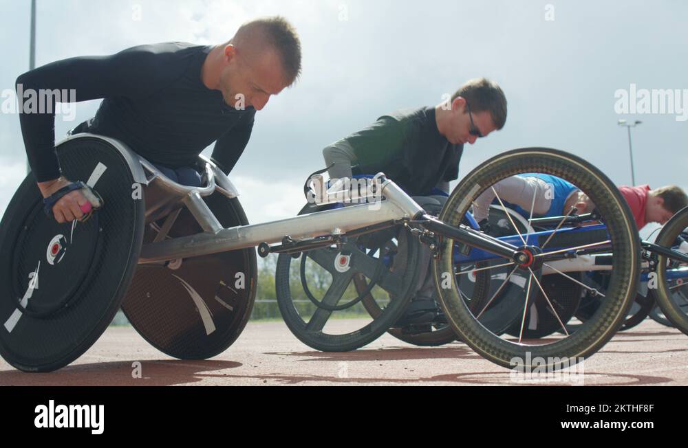 4K Disabled wheelchair athletes competing in a race wait at starting ...