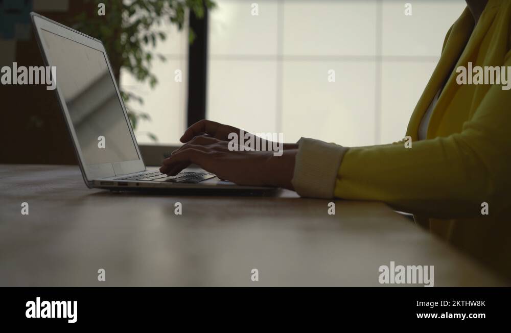 Unrecognisable woman typing on the computer in the modern office with ...