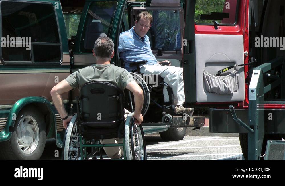 Two men in wheelchairs exit van Stock Video Footage - Alamy