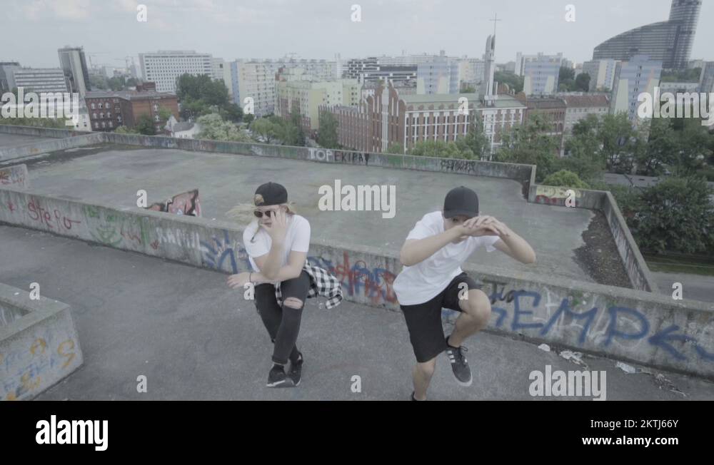 Video of active young couple dancing hip hop on the rooftop with city ...