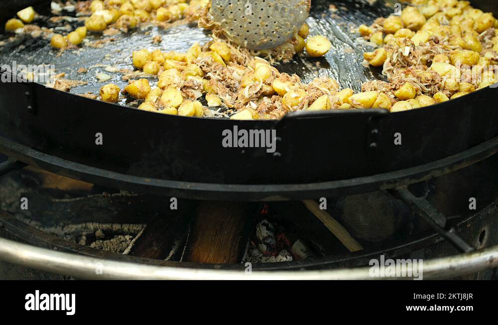 Chef cooking fried potato in big pan on fire Stock Video Footage - Alamy