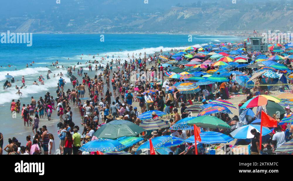 Crowd of people swim in the Pacific Ocean in Santa Monica Beach, Los ...