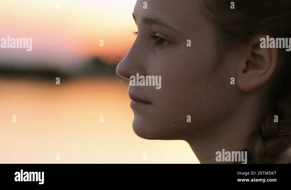 calm face: Side profile of girl relaxing and enjoying quiet evening on ...
