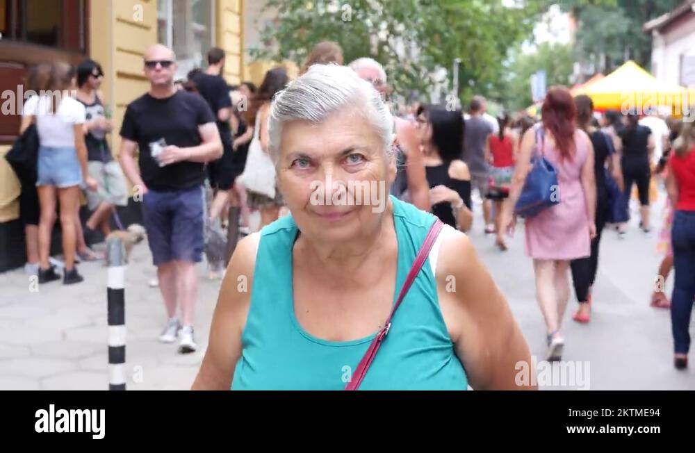 Debonair senior old age woman portrait walk down urban culture festival ...