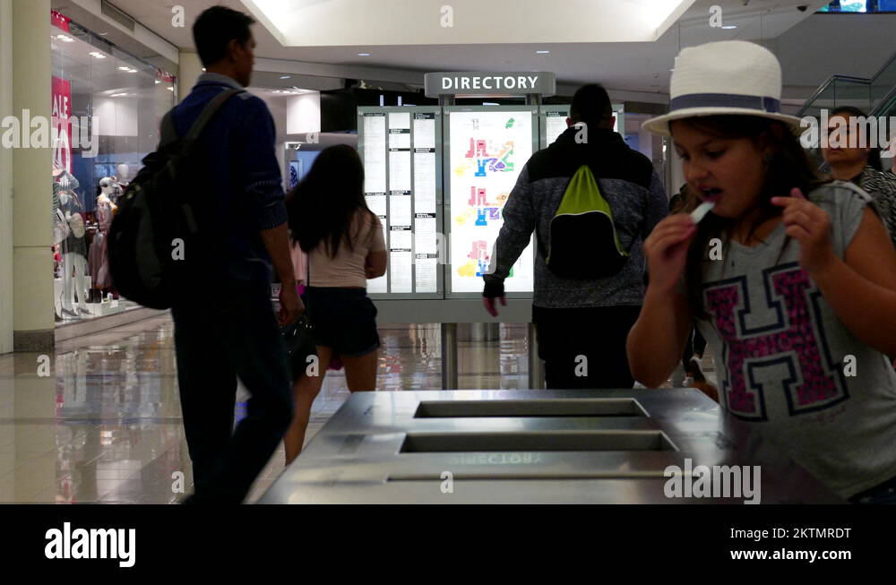 Girl throwing garbage to garbage can inside Burnaby shopping mall Stock ...
