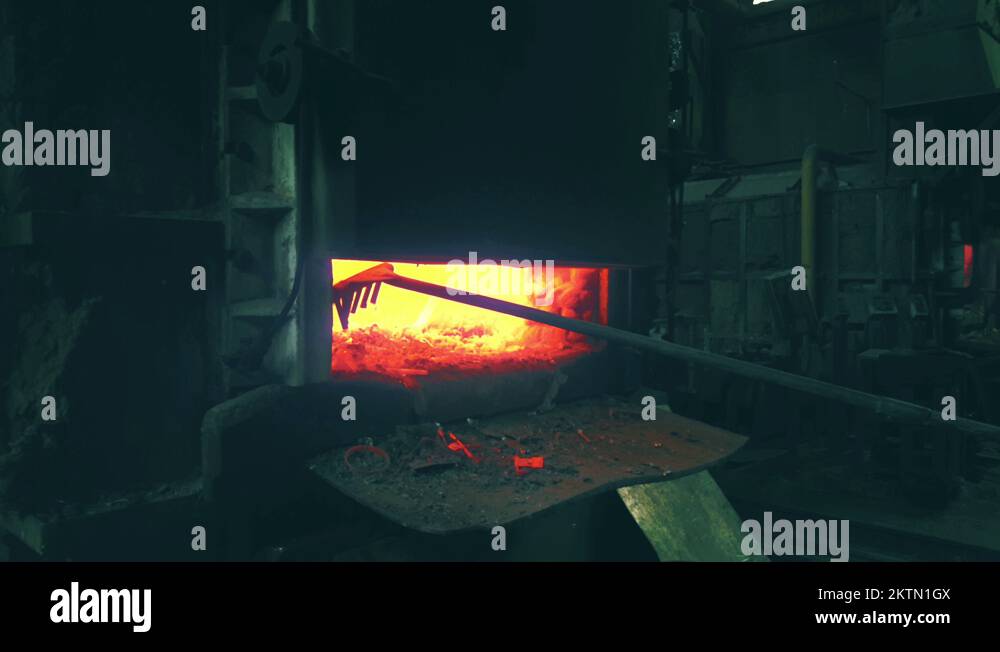 Steelmakers rake the slag from the melting of the metal Stock Video ...