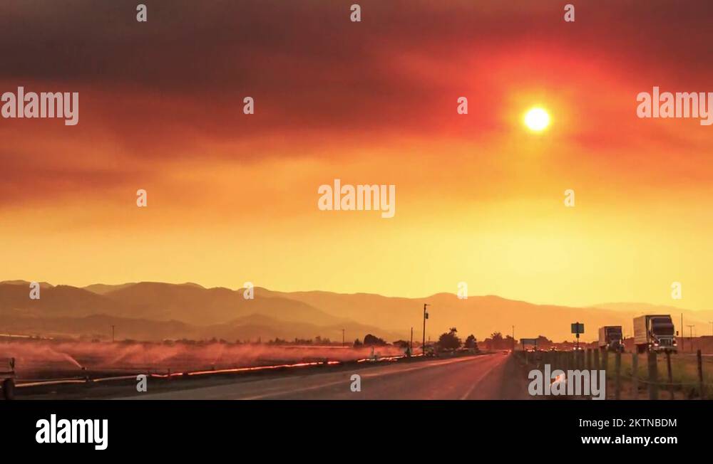 Smoke cloud from wildfire fire over freeway California sunset Zoom in on sun Stock Video Footage ...