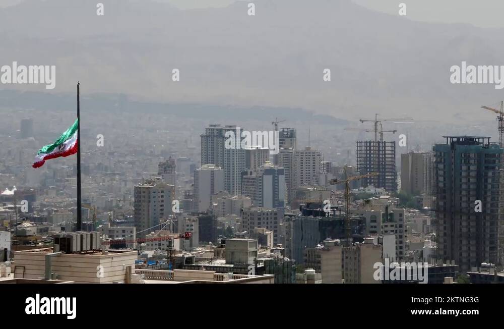 Iranian flag waving in the middle of Tehran the capital city of Iran ...