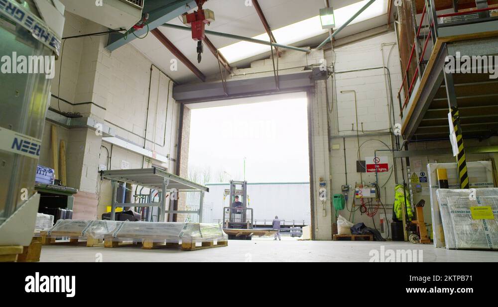 4K Worker in warehouse using forklift truck to move empty wooden ...