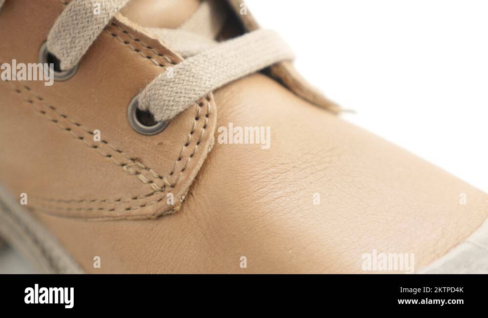 Beige color odern woman boots details of stiches and shoestring tilting ...