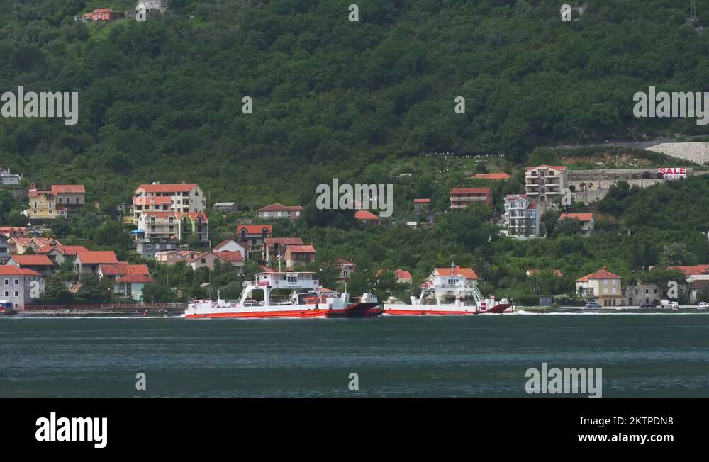 Two ferry boats cruising in Bay of Kotor in Lepetane, Montenegro Stock ...