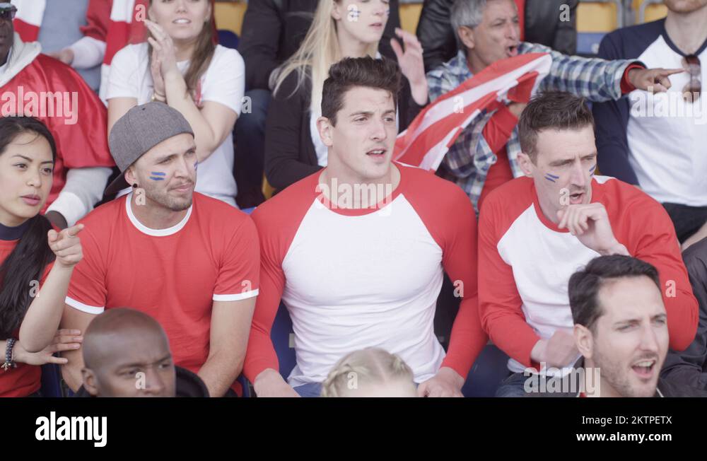 4K Crowd of spectators watching sports game in stadium shouting at the ...