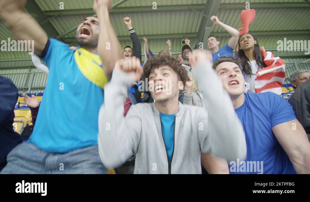 4K Excited sports crowd with national flags celebrating & cheering on ...