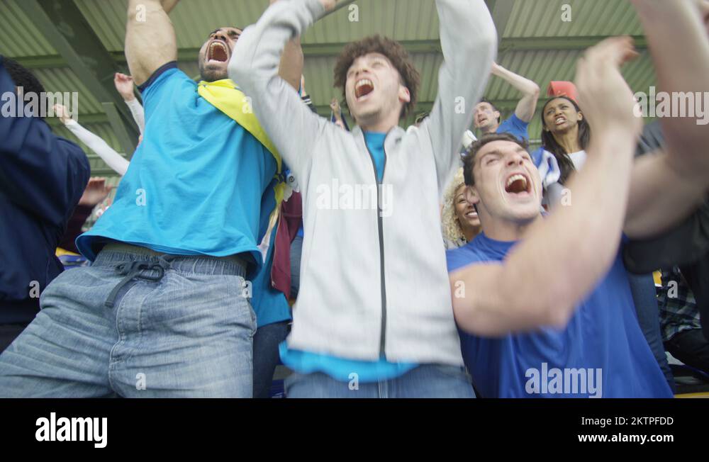 4K Excited sports crowd with national flags celebrating & cheering on ...