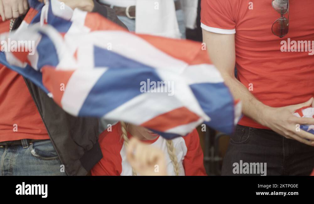 4K Excited fans with British flags in sports crowd cheering on the team ...