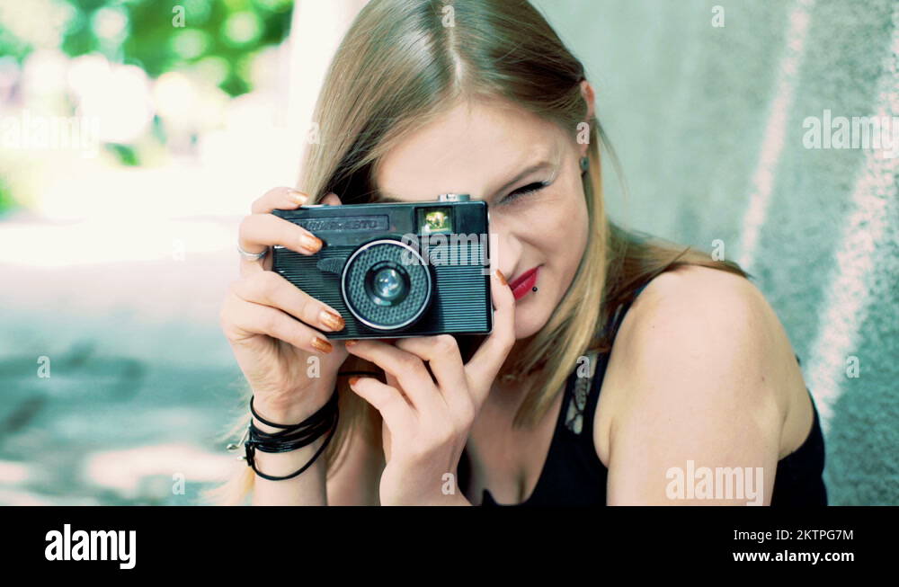 Punk girl doing photos on her old camera and enjoying this Stock Video ...