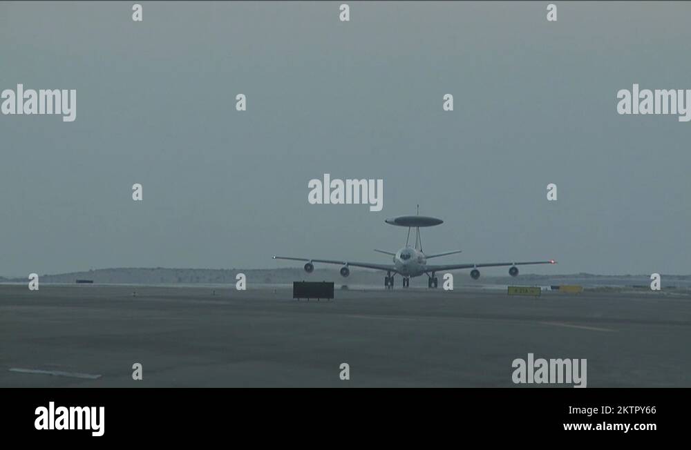 A U.S. Air Force E-3 Sentry AWACS plane lands and taxis on a runway ...