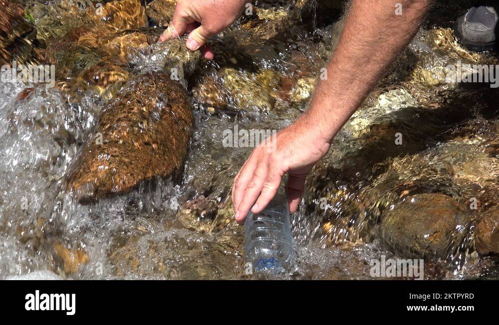 Tourist Make Water Supply for Mountain Trip Fill a Bottle from a Stream ...
