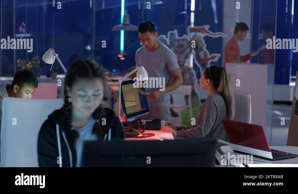 4K Young Asian computer design team collaborating on project in ...