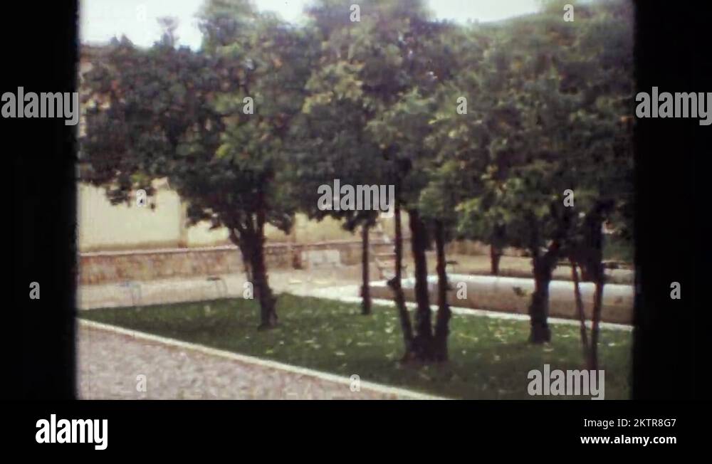 1972: two people stoop in large, empty courtyard under a dark sky IRAN ...