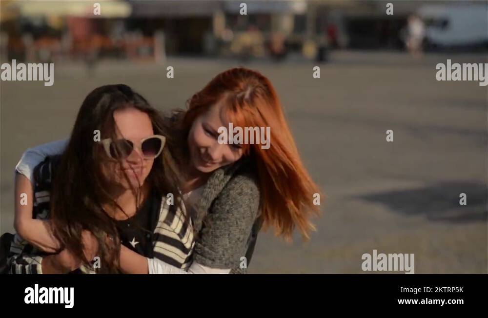 Two girl friends young female friends giving piggyback on vacation ...
