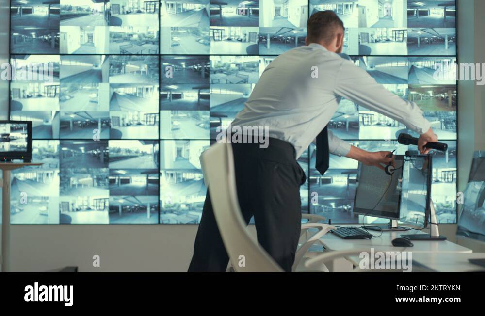 4K Security officer alone in observation control room does a little ...