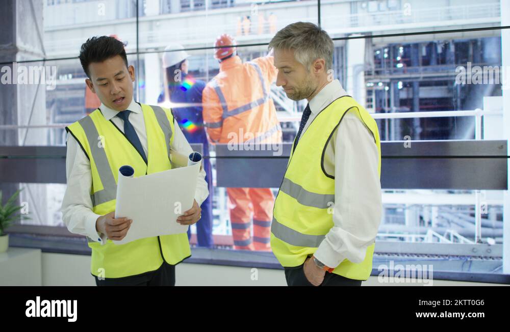 4K Power station control room workers checking plans & watching ...