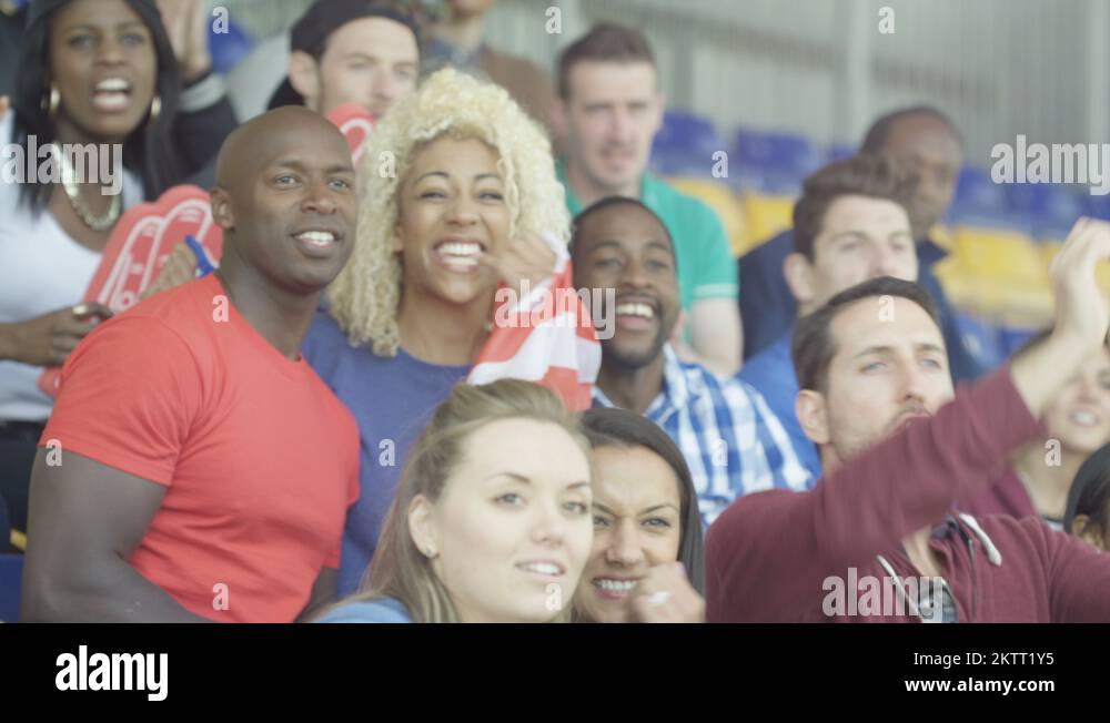 4K Excited fans with US flag in sports crowd, celebrating & cheering on ...