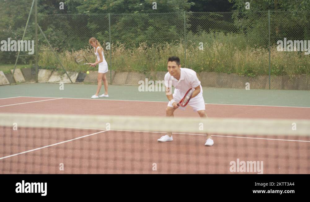 4K Male & female tennis players serving & scoring a point on outdoor ...