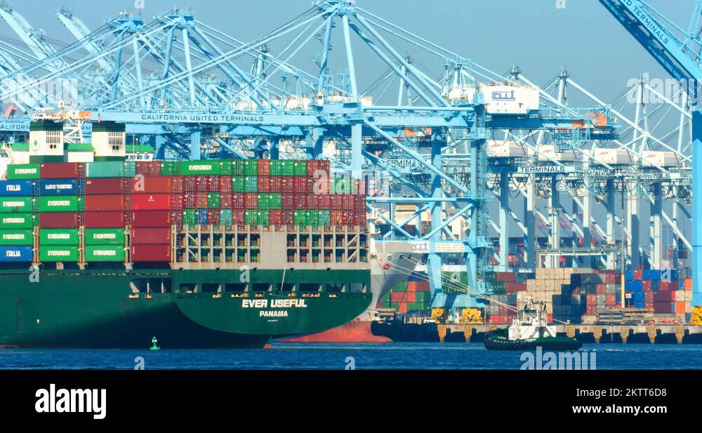 Cargo container ship and pusher tugs enter the sea port during the heat ...
