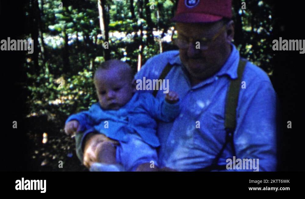 1961: fat parents with lean babies standing and posing beside their car ...
