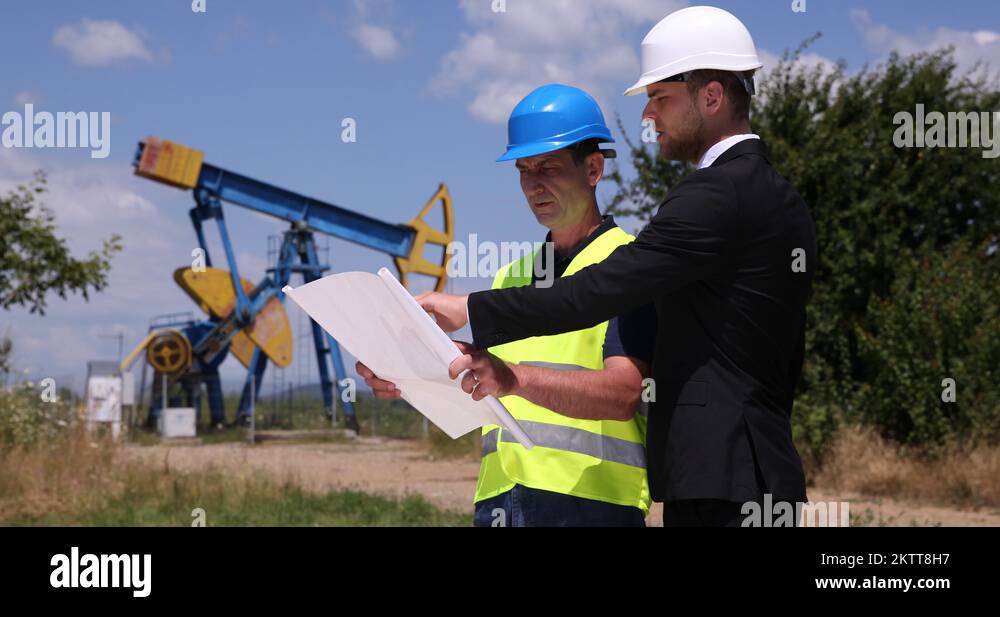 Engineer and Businessman Talk Pumping Unit Plan Teamwork Assistance Oil ...