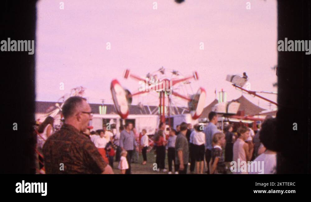 1963: pendulum ride swings while visitors stand and walk through ...