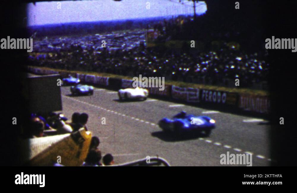 1955: men racing cars around a race car track as people watch LE MANS ...