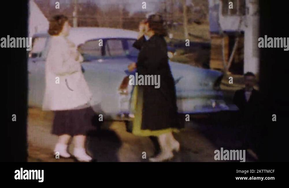 1956: women and child exit car in driveway and pose for a picture ...