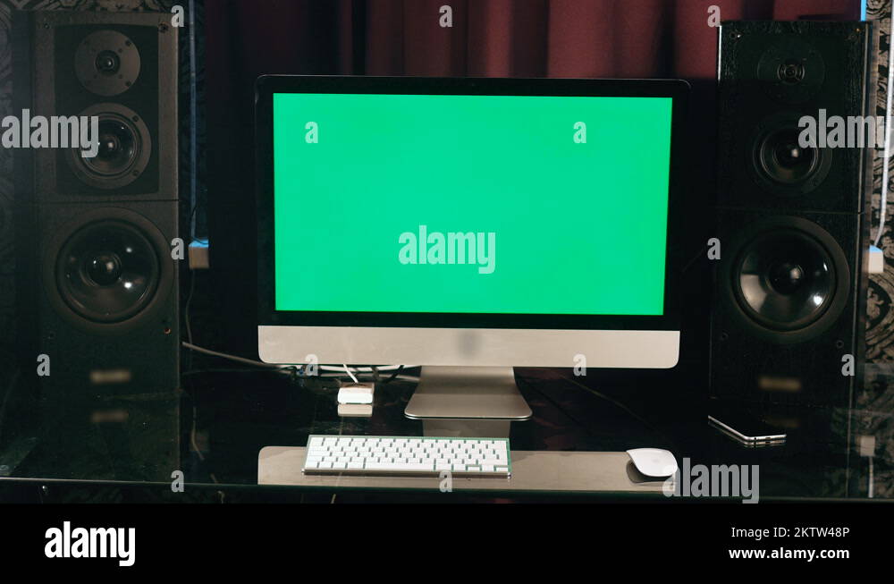 Chroma key. Stylish workspace with computer green screen and audio ...