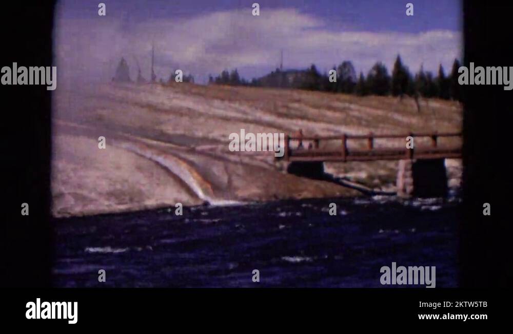 1967: water is falling over the rock to the blue water body with a ...