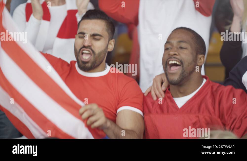 4K Excited fans with US flag in sports crowd, celebrating & cheering on ...